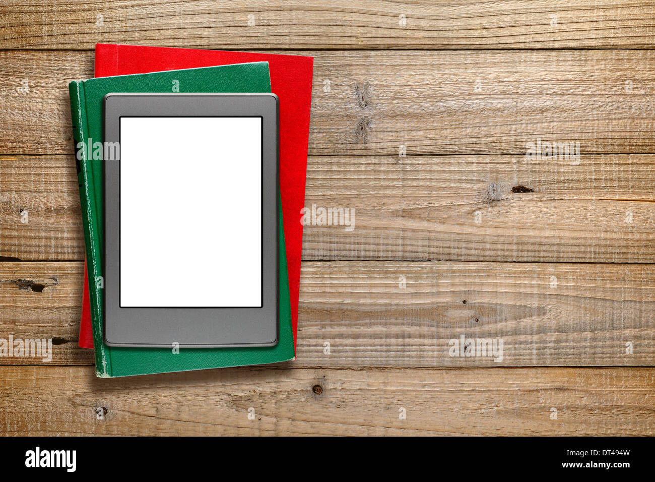 Ereader and old books on wooden background Stock Photo - Alamy