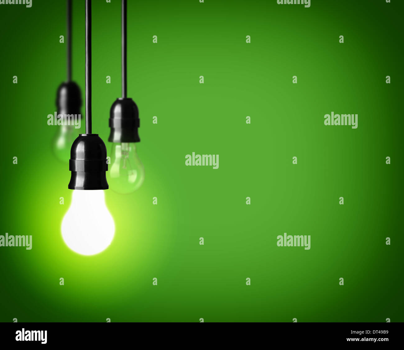 Light bulbs on green background Stock Photo - Alamy