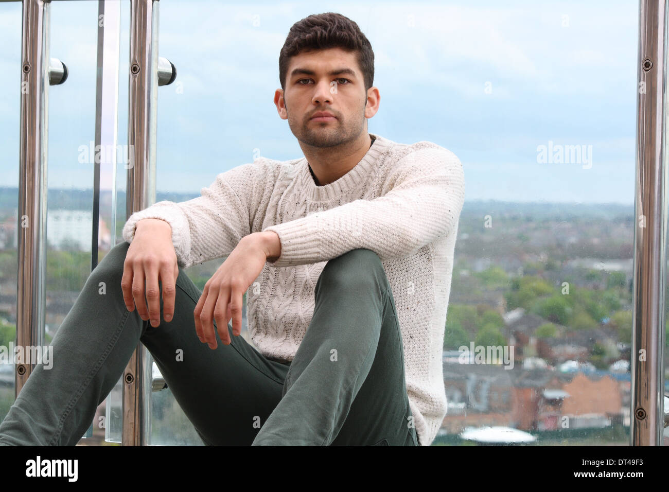 A male model sitting Stock Photo - Alamy
