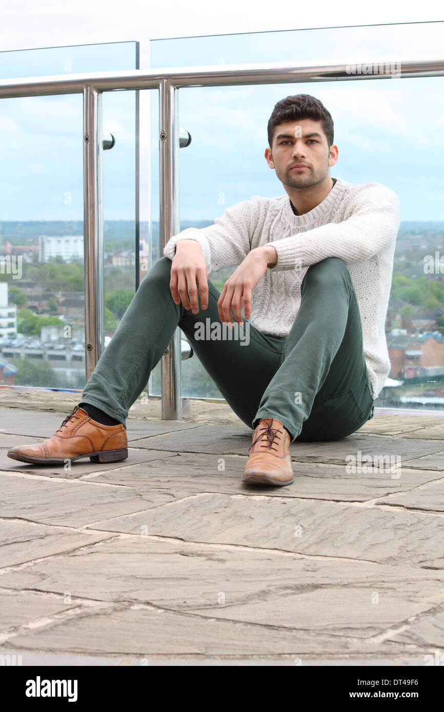 A male model sitting Stock Photo - Alamy