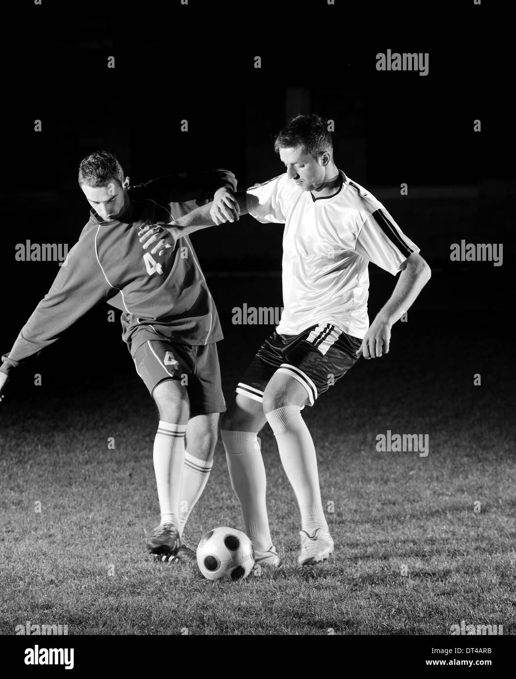 football players in action for the ball Stock Photo - Alamy