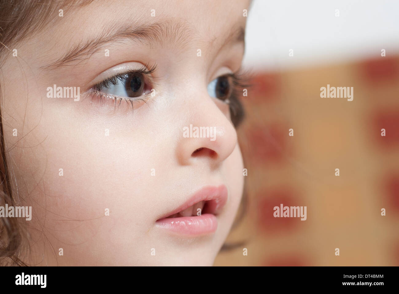 Serious little girl looking away Stock Photo - Alamy