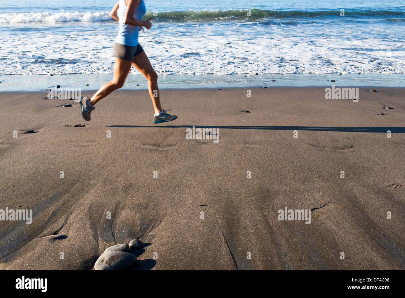 Jogging and running early in the morning on the beach in El Tunco, a ...