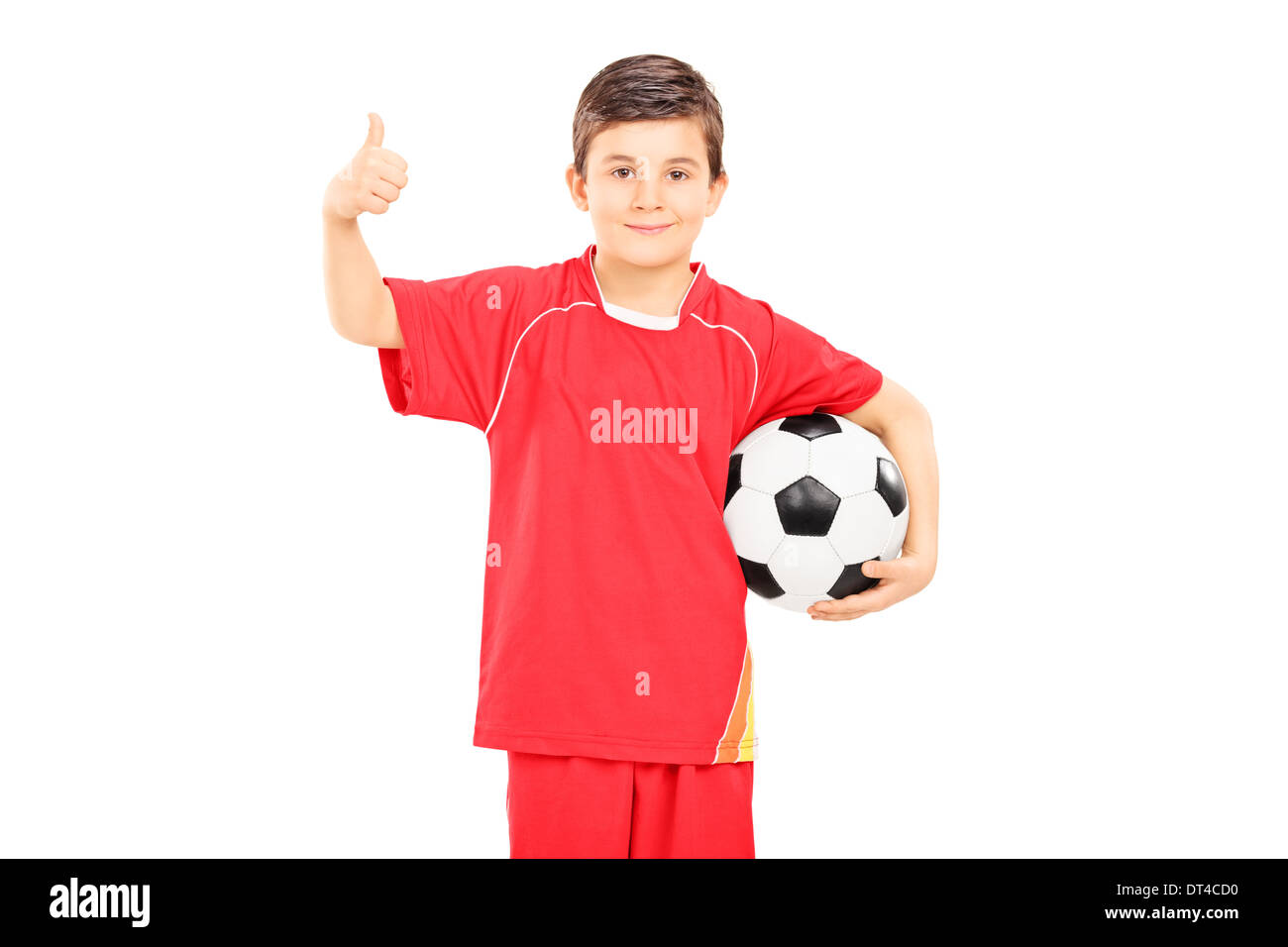 Boy in sportswear holding a football and giving thumb up Stock Photo ...