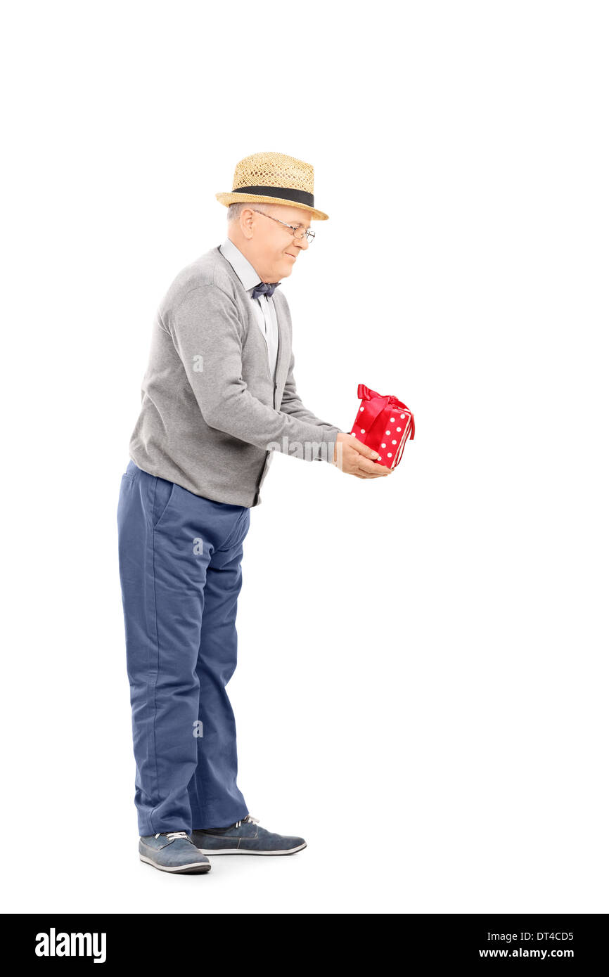 Full length portrait of senior gentleman holding present Stock Photo ...