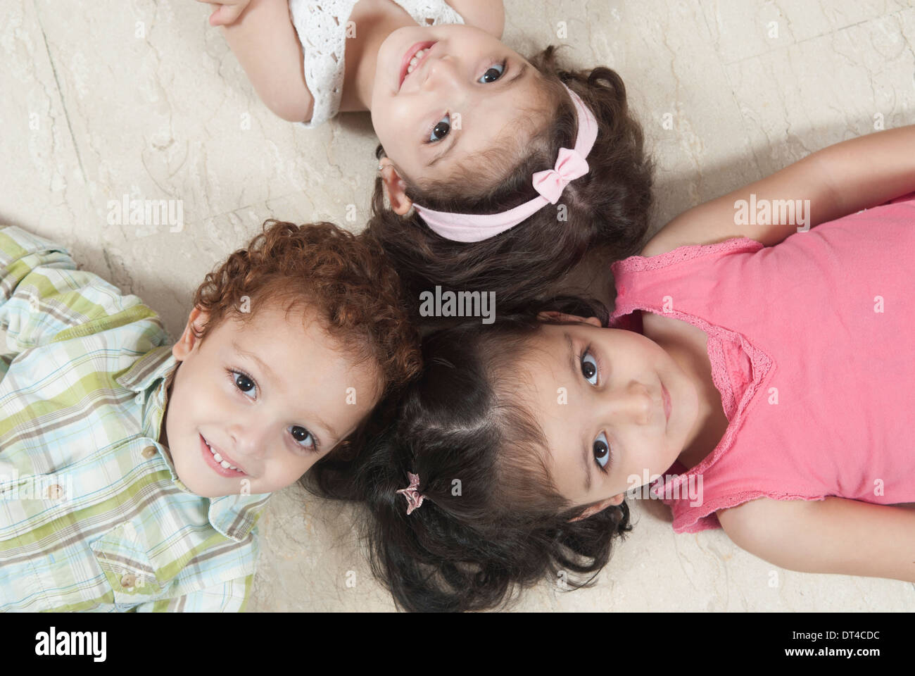 Triplets on the floor Stock Photo - Alamy