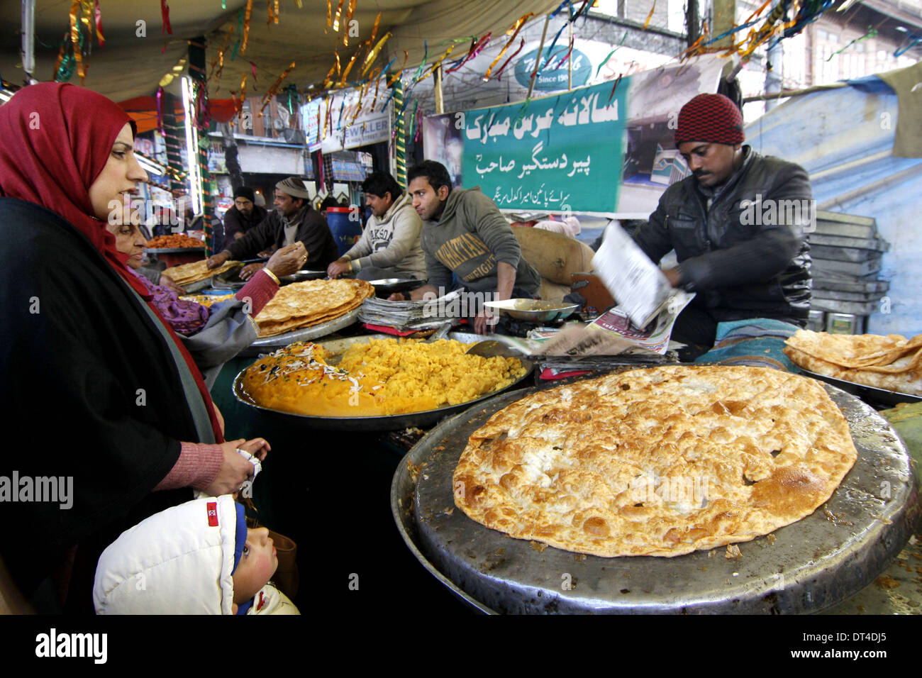 Indian Kashmirm, India. 8th Feb, 2014. A Kashmiri muslim woman buys ...