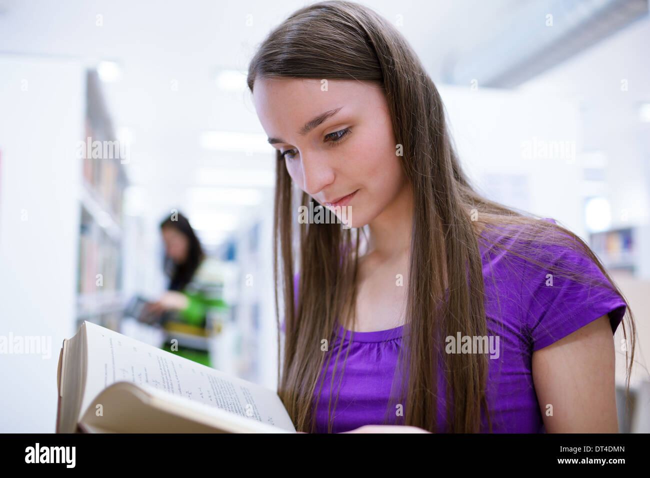 In the library - pretty, female student searching for books in a high ...