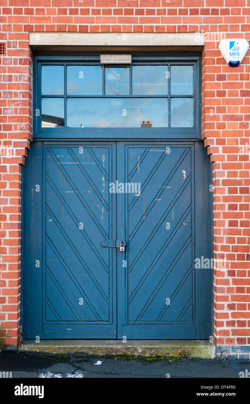 Padlocked blue double doors in a brick wall Stock Photo - Alamy