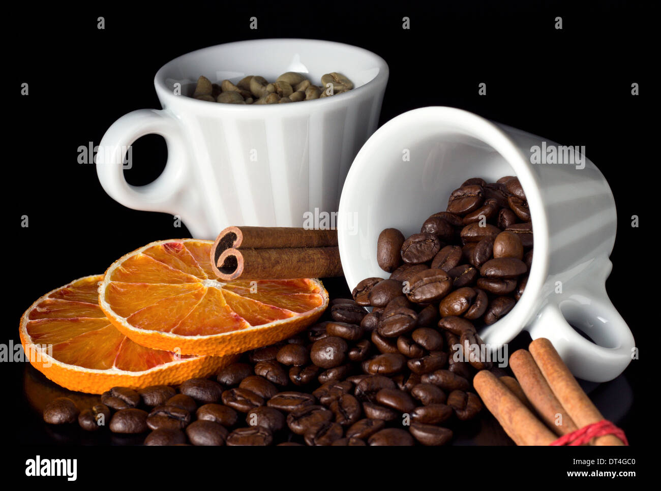 coffee cups with roasted beans and orange Stock Photo - Alamy
