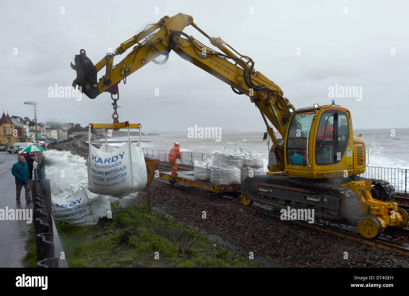 Dawlish, UK. 8th Feb, 2014. Aggregate is loaded onto a rail carriage to ...