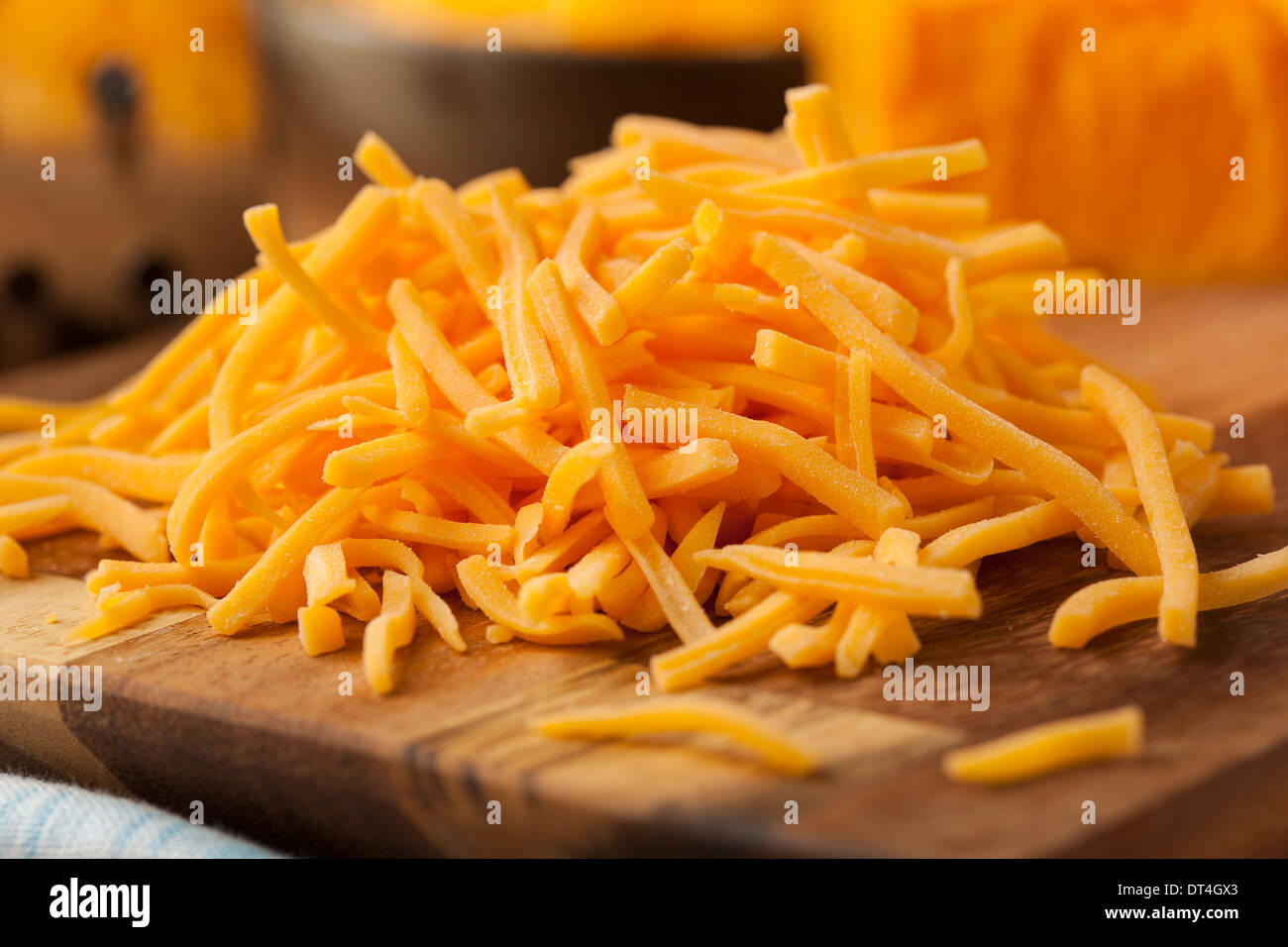 Organic Shredded Sharp Cheddar Cheese on a Cutting Board Stock Photo ...
