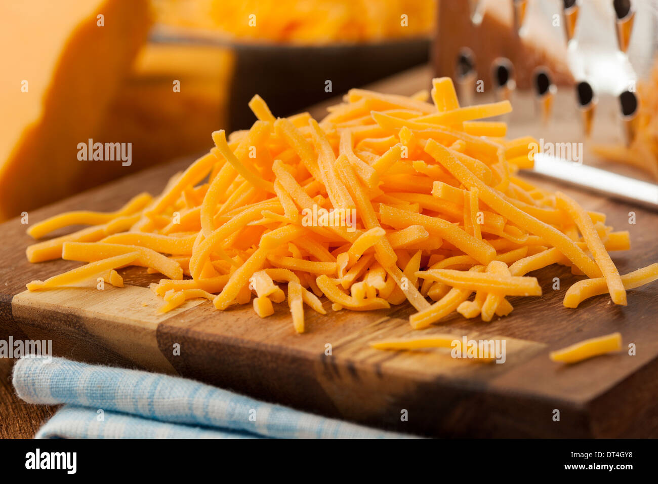 Organic Shredded Sharp Cheddar Cheese on a Cutting Board Stock Photo ...
