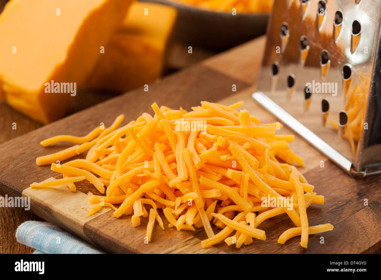 Organic Shredded Sharp Cheddar Cheese on a Cutting Board Stock Photo ...
