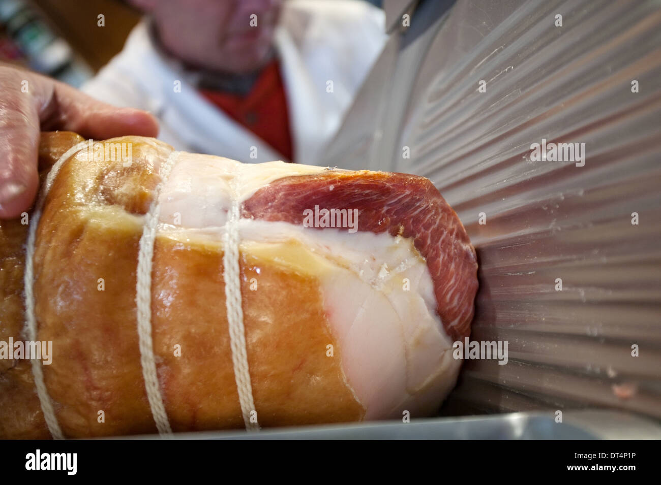 prosciutto ham closeup view on shop cutter background Stock Photo - Alamy