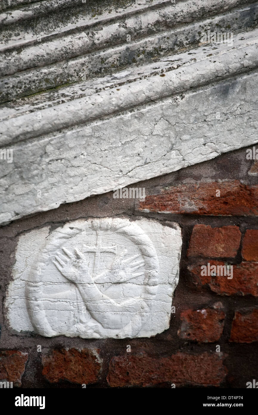 bas-relief with hands and cross on old bridge in Venice, closeup front ...