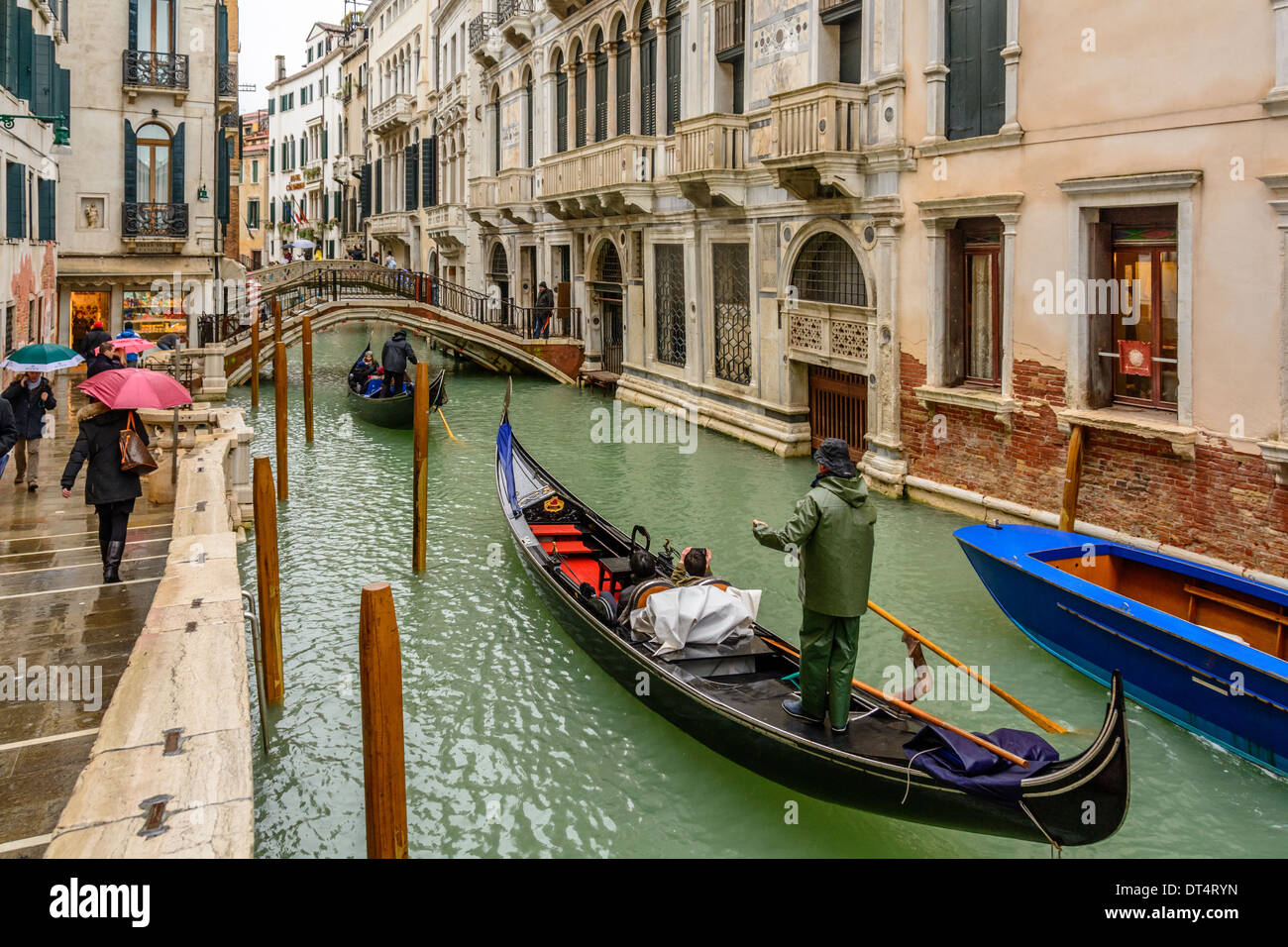 Venice, Italy. Two Venetian Gondolas with passengers navigating on a ...