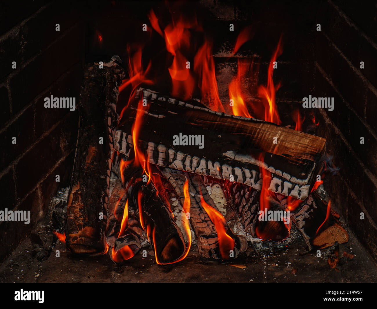 Fireplace with birch firewood and flame. Closeup Stock Photo - Alamy