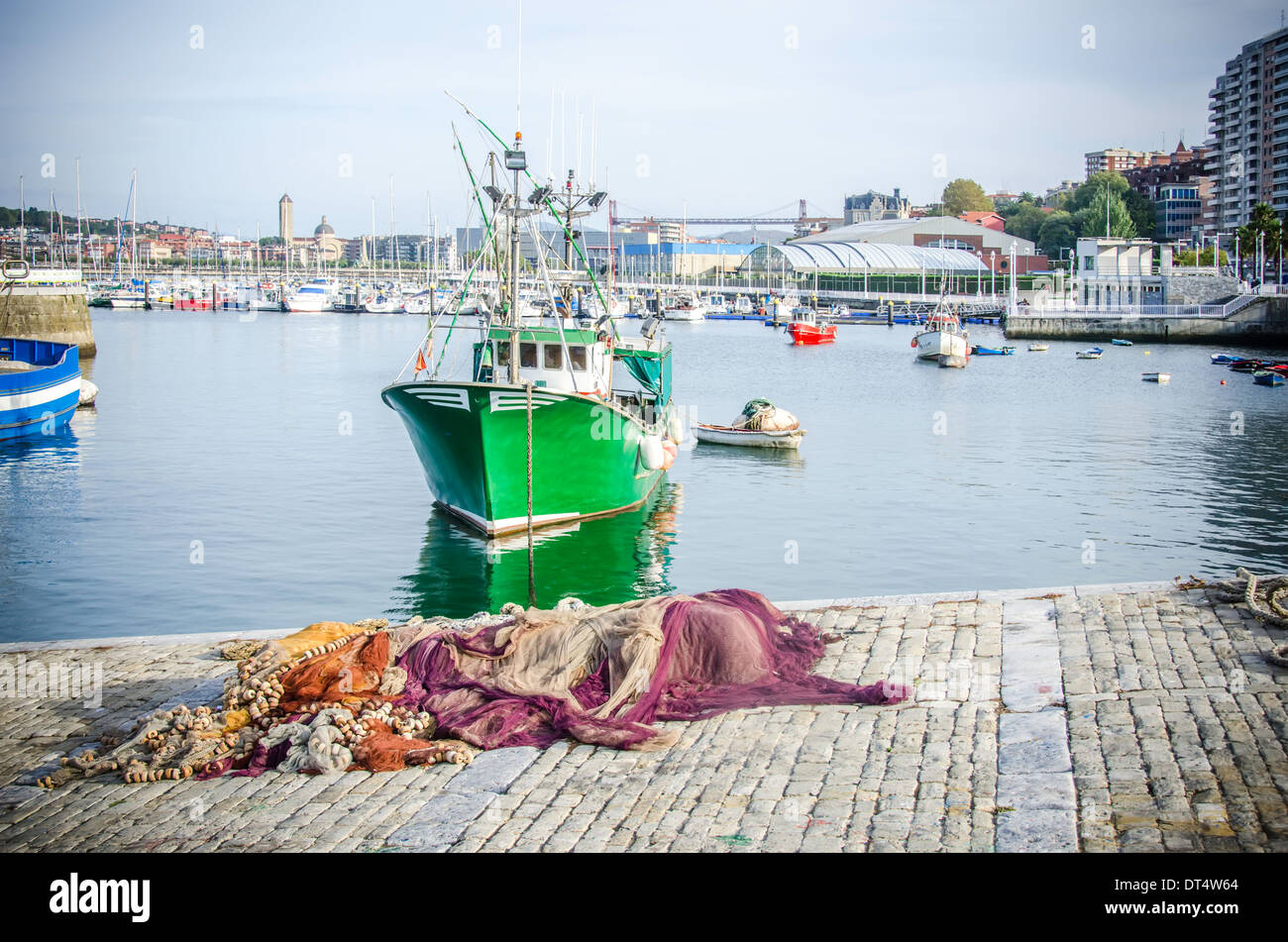 Green fishing boat in port Stock Photo - Alamy