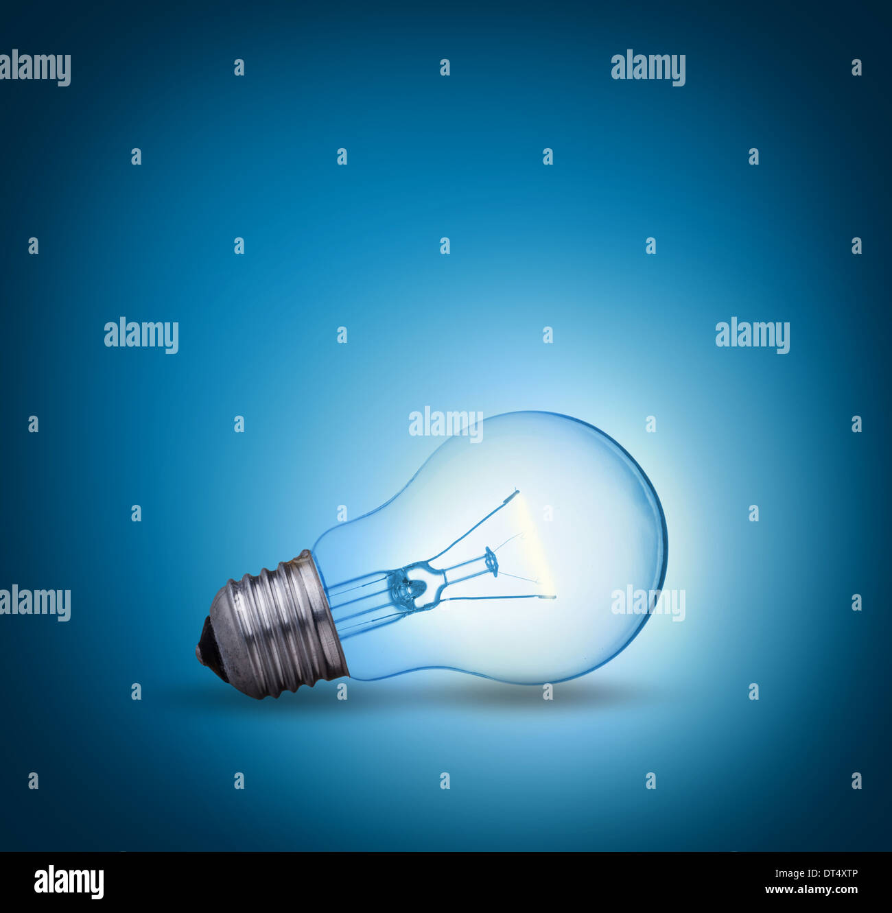 light bulb on blue background on the ground side Stock Photo - Alamy