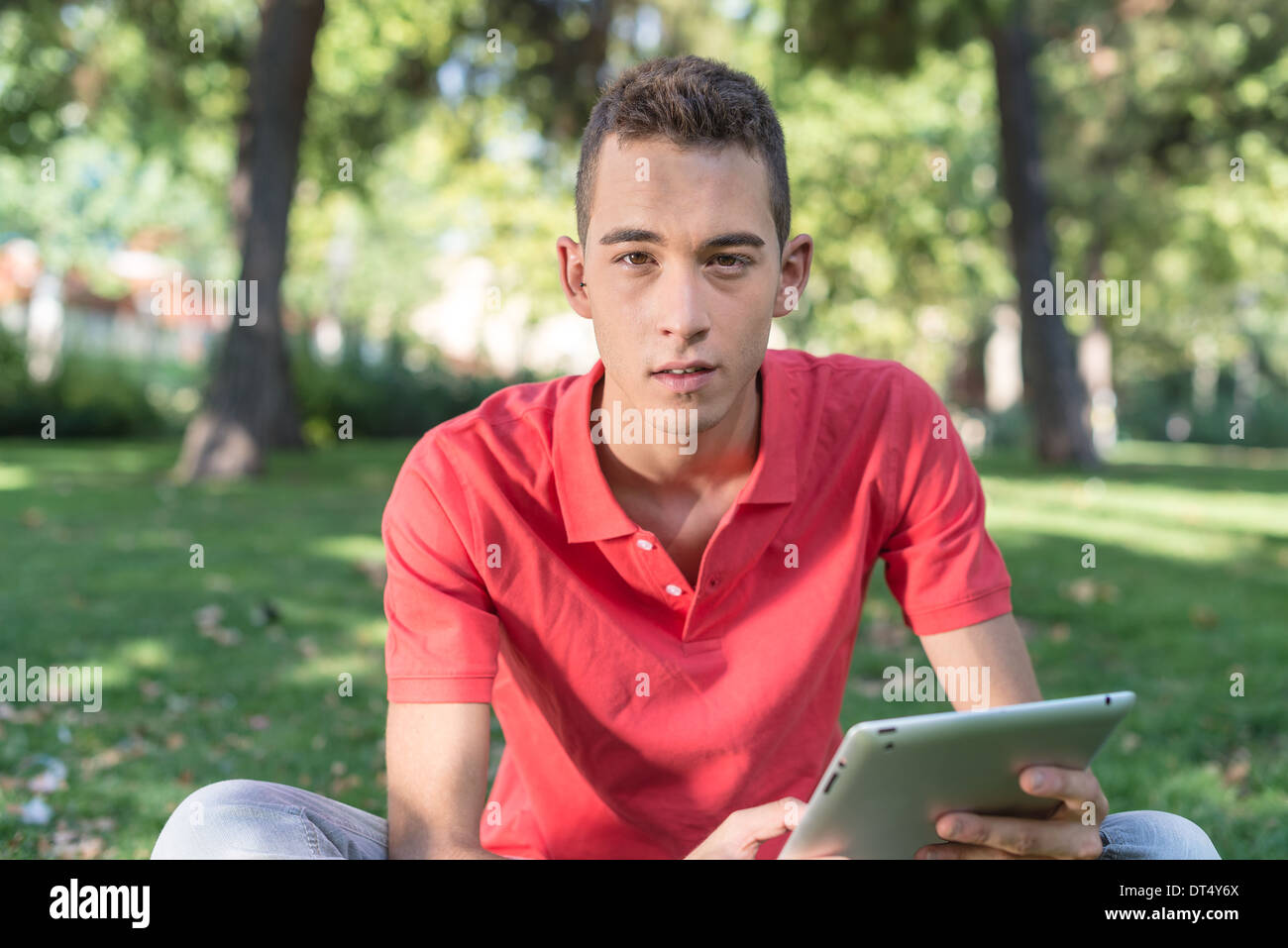 Young man with tablet outdoor Stock Photo - Alamy