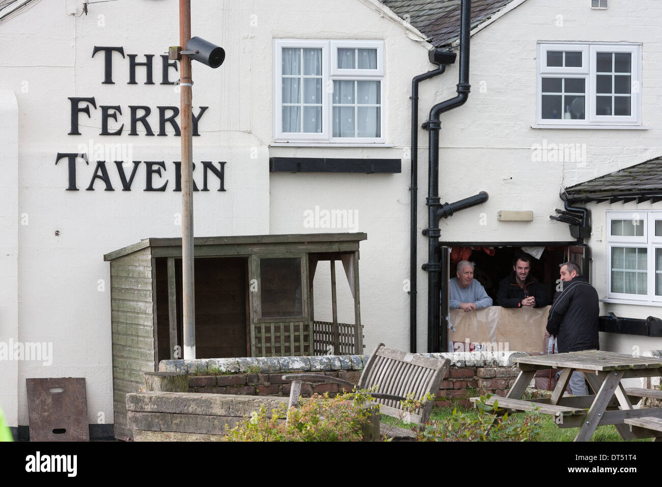 Staff stand behind flood defenses at the Ferry Tavern, which stands on ...