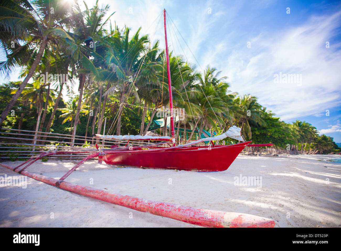 Filipino red boat on the white sand beach in Boracay island ...
