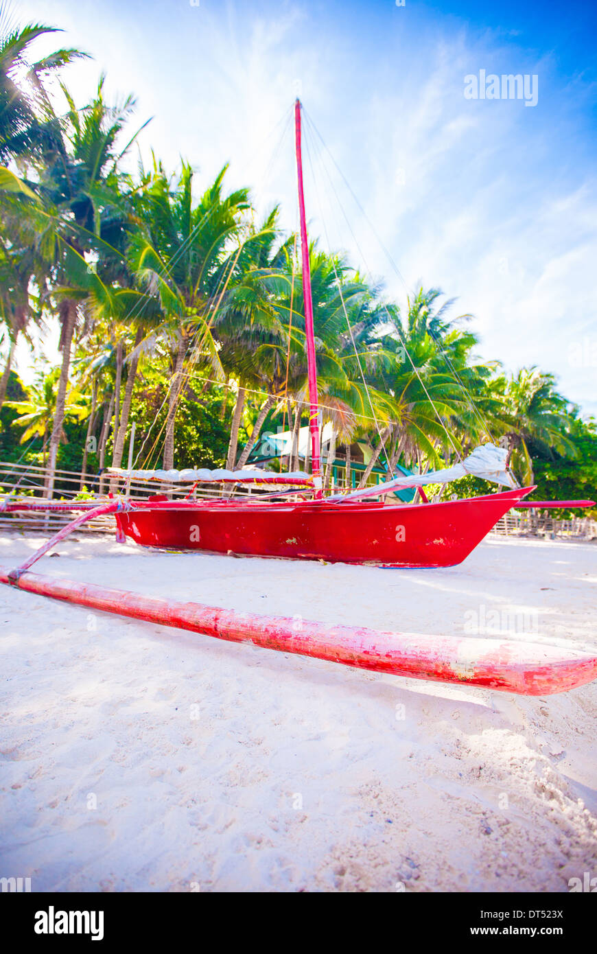 Filipino red boat on the white sand beach Stock Photo - Alamy