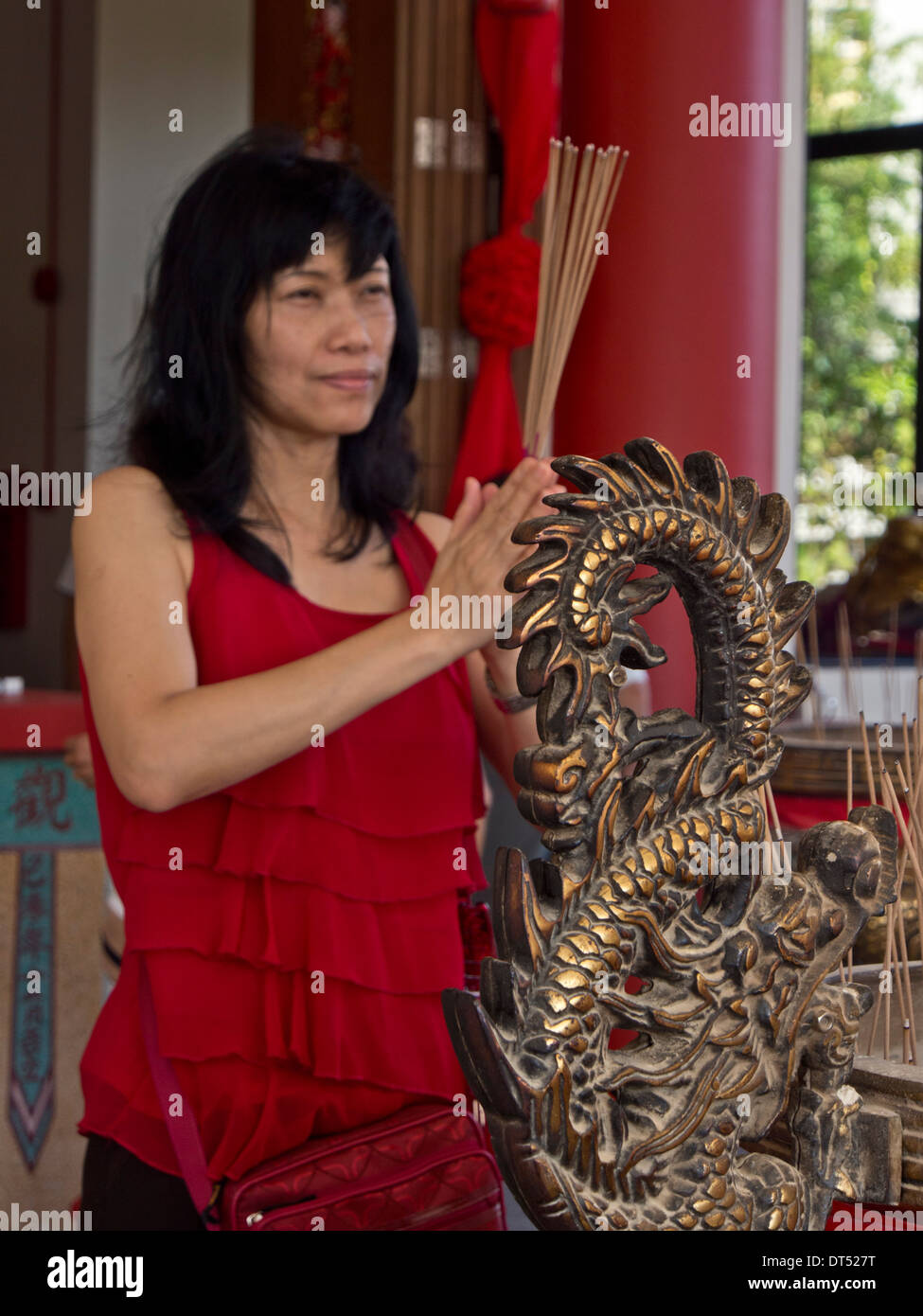 Woman praying and paying respect at a temple on the eve of Chinese New ...