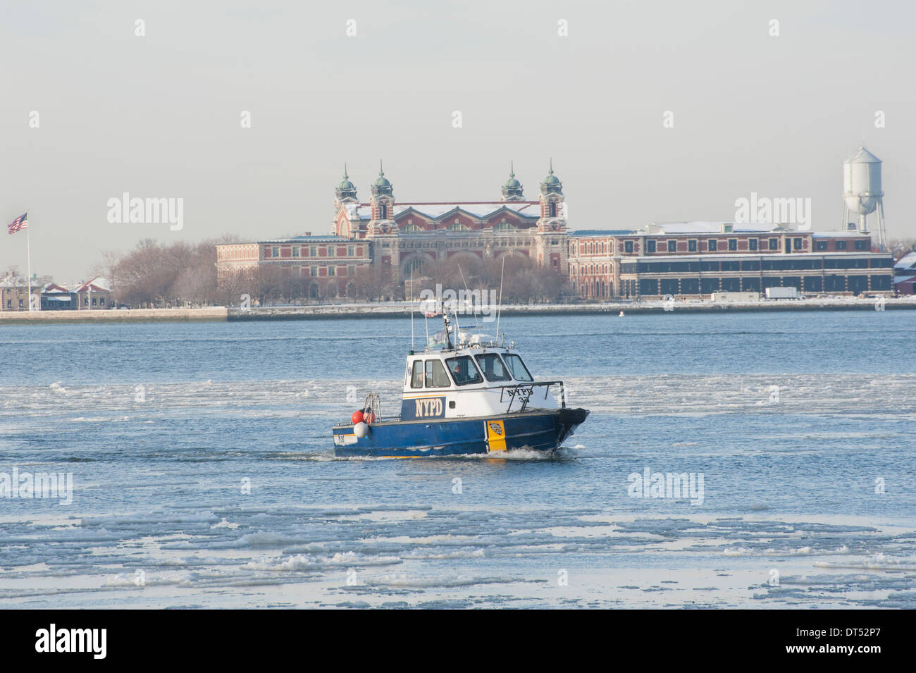 An New York Police Department boat makes its way slowly up the icy ...