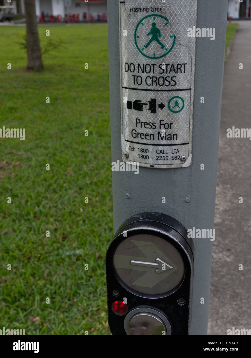 Traffic sign with warning to pedestrians in Singapore Stock Photo - Alamy