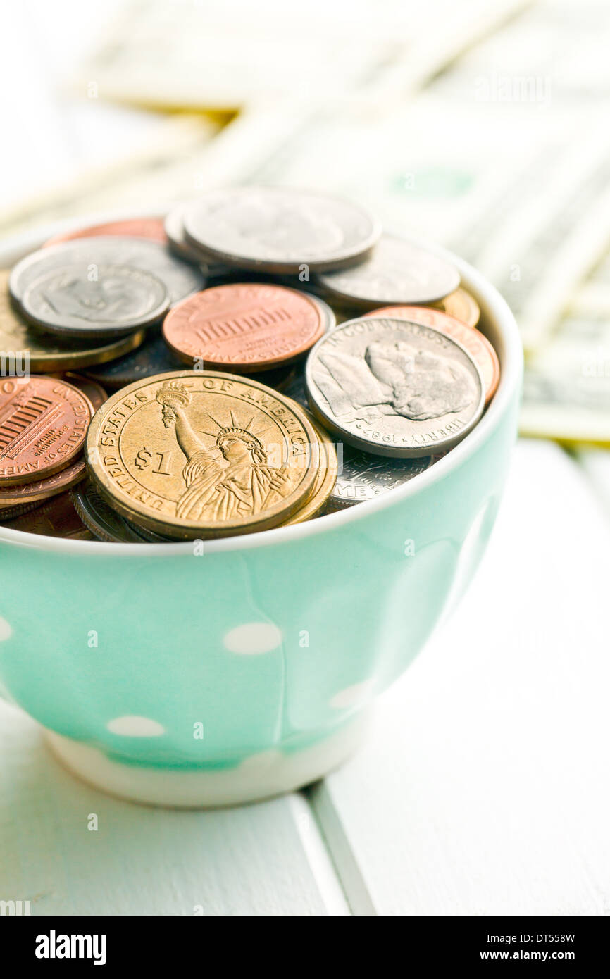 U.S. coins in ceramic bowl on wooden table Stock Photo - Alamy