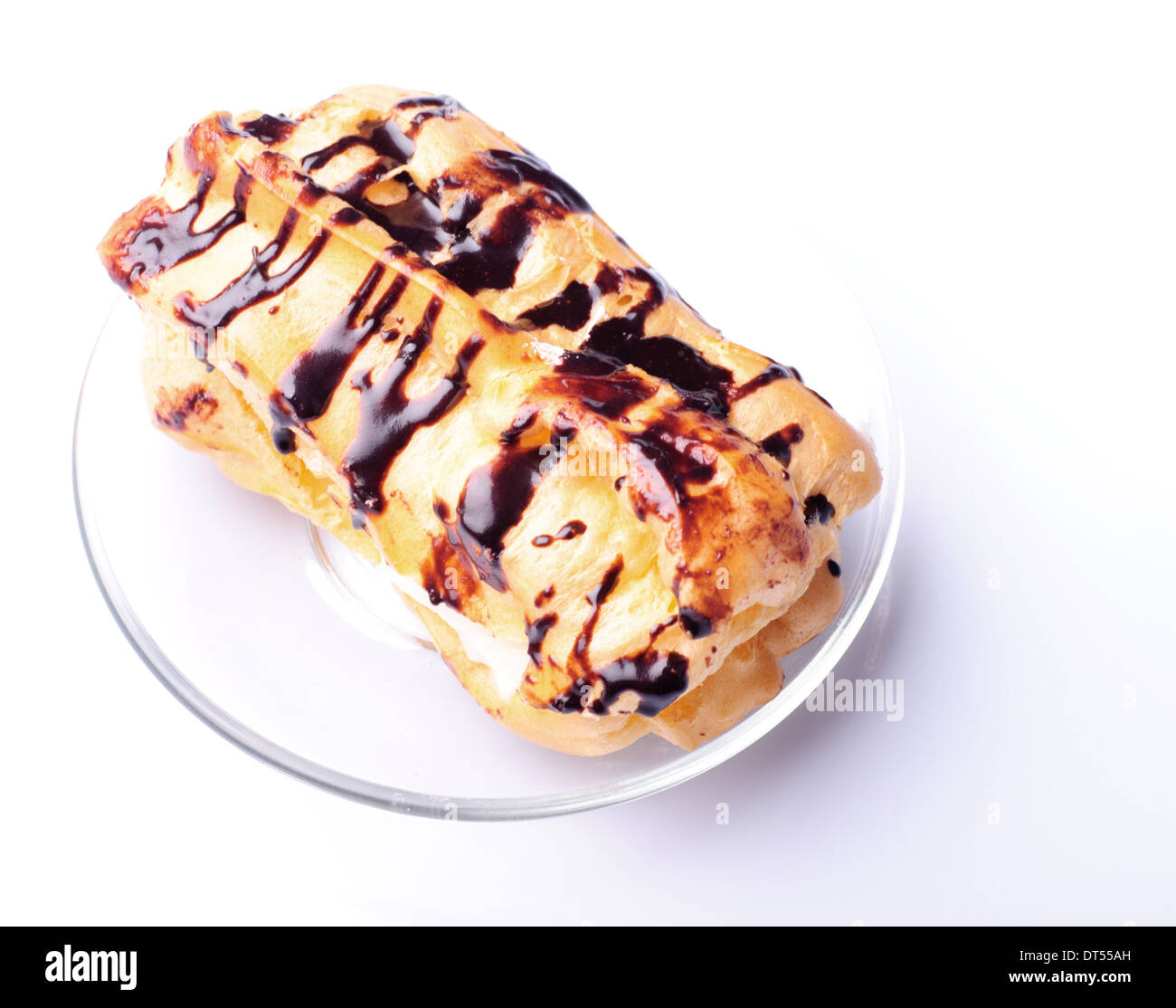 Eclair on plate isolated on white background Stock Photo - Alamy