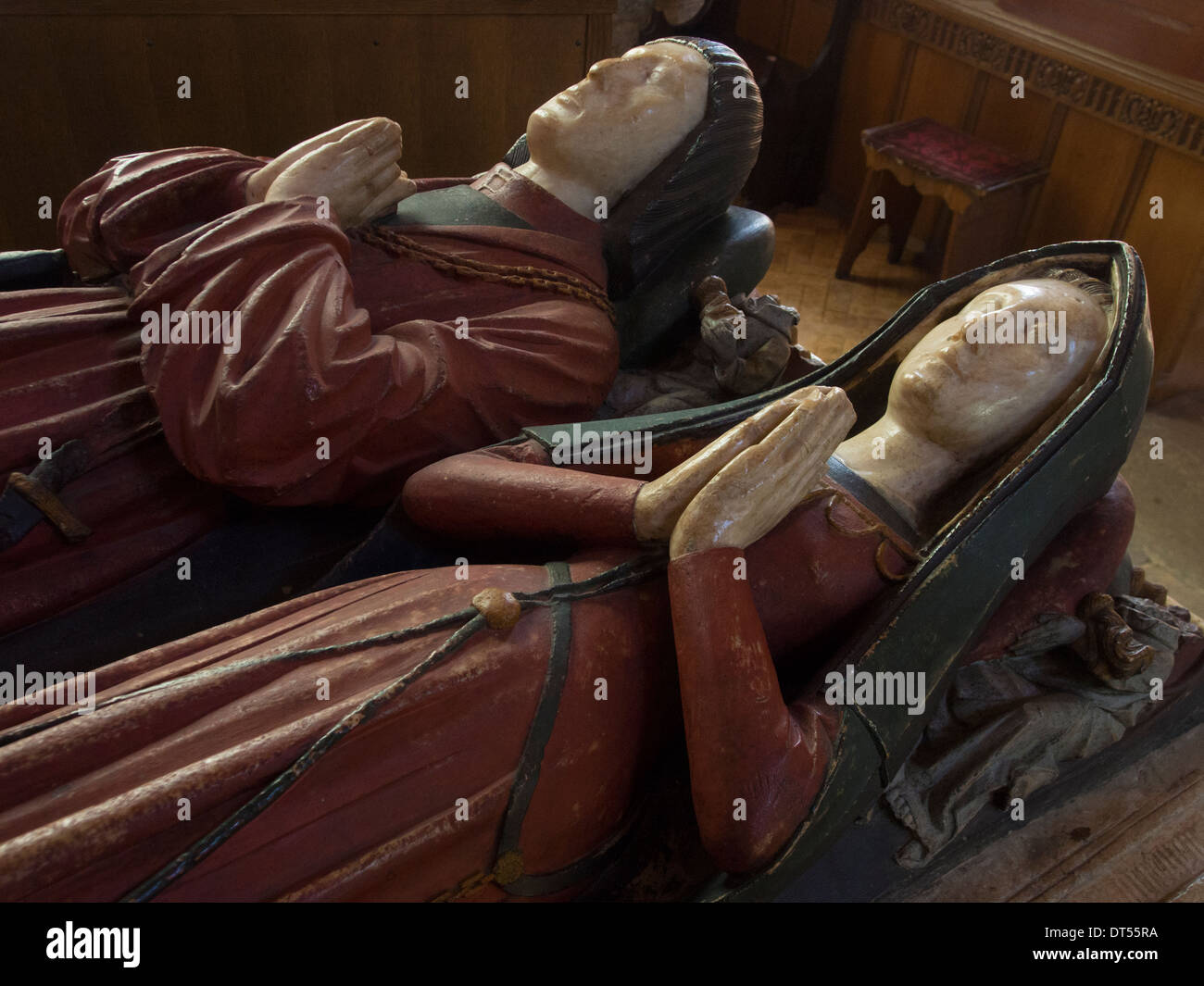 Two tomb effigies, painted in realistic colours lie peacefully side-by ...