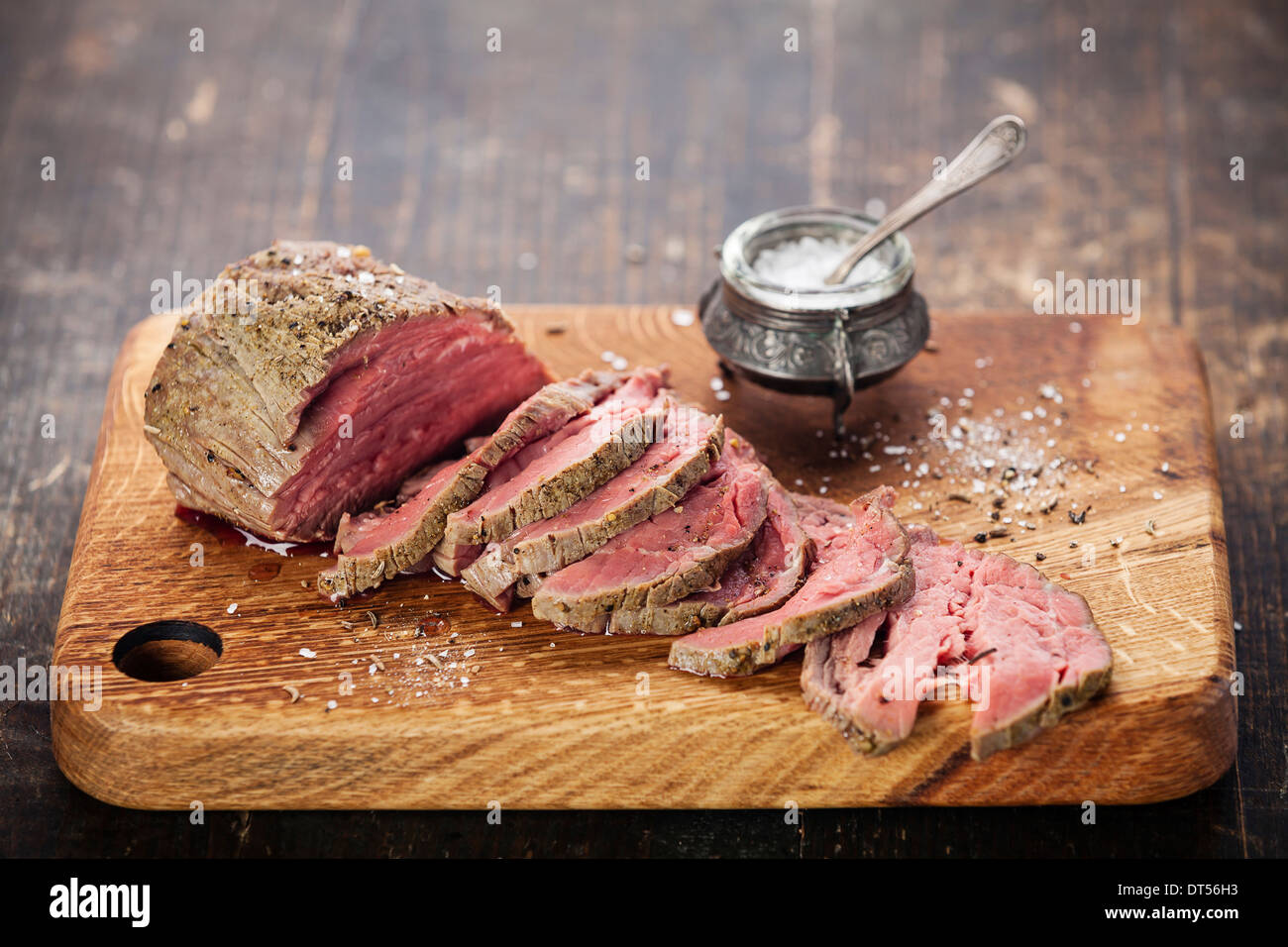 Roast beef on cutting board and salt cellar Stock Photo - Alamy
