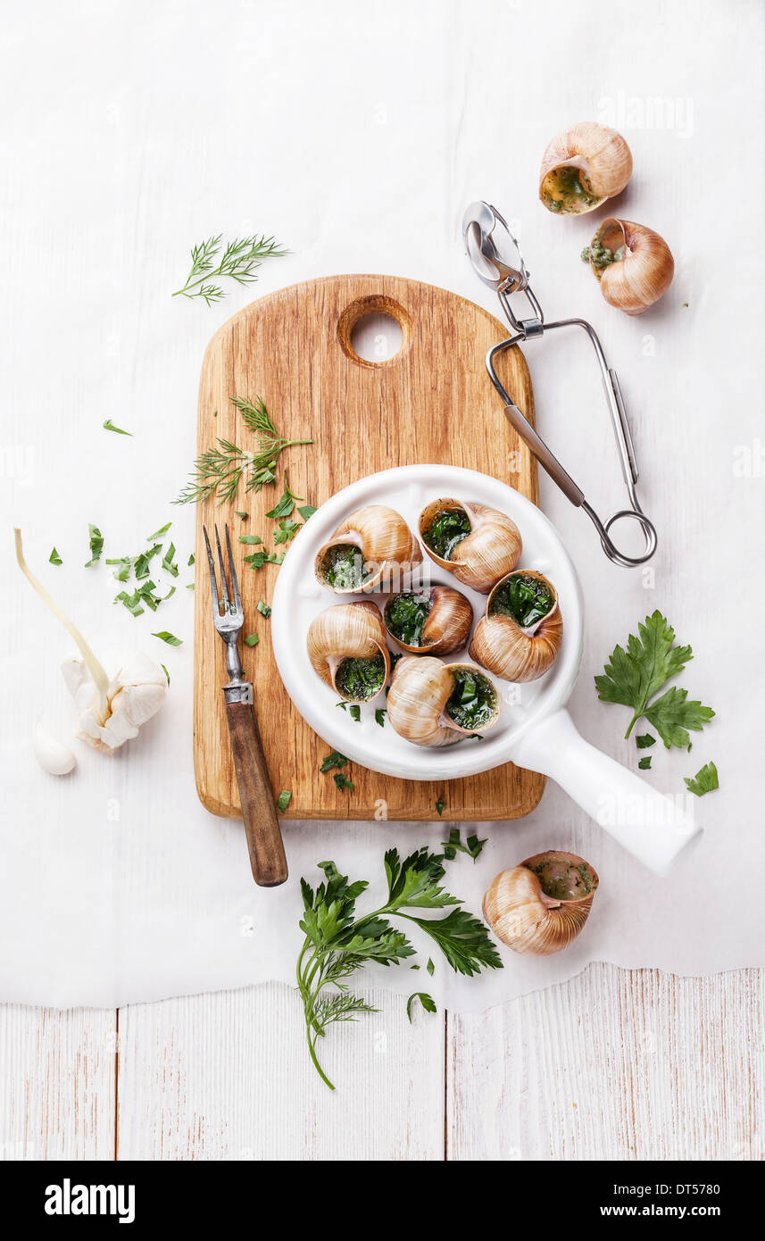 Baked snails with garlic butter sauce and fresh greens Stock Photo - Alamy