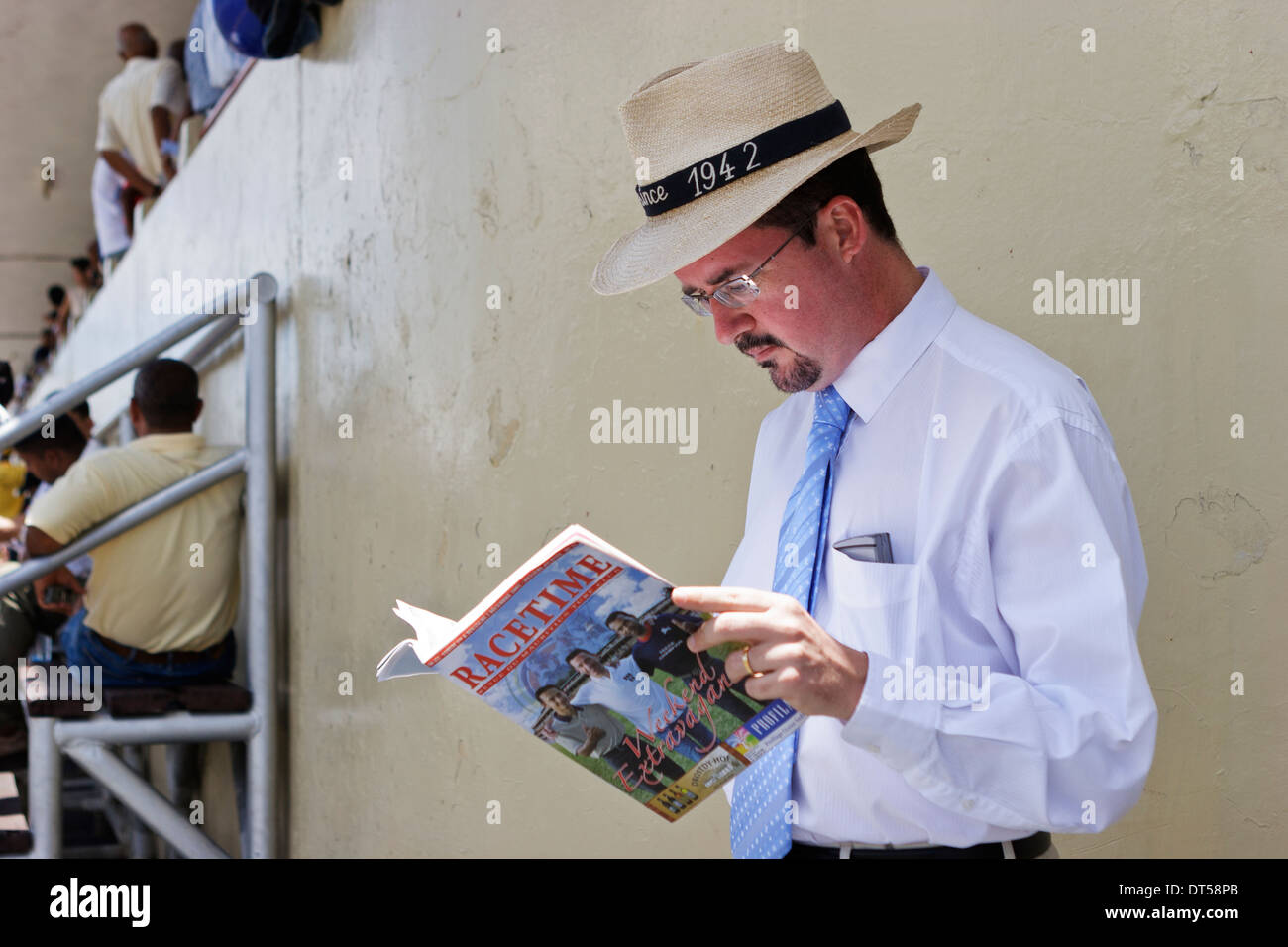 A spectator checking out the horse racing timetable before the next ...