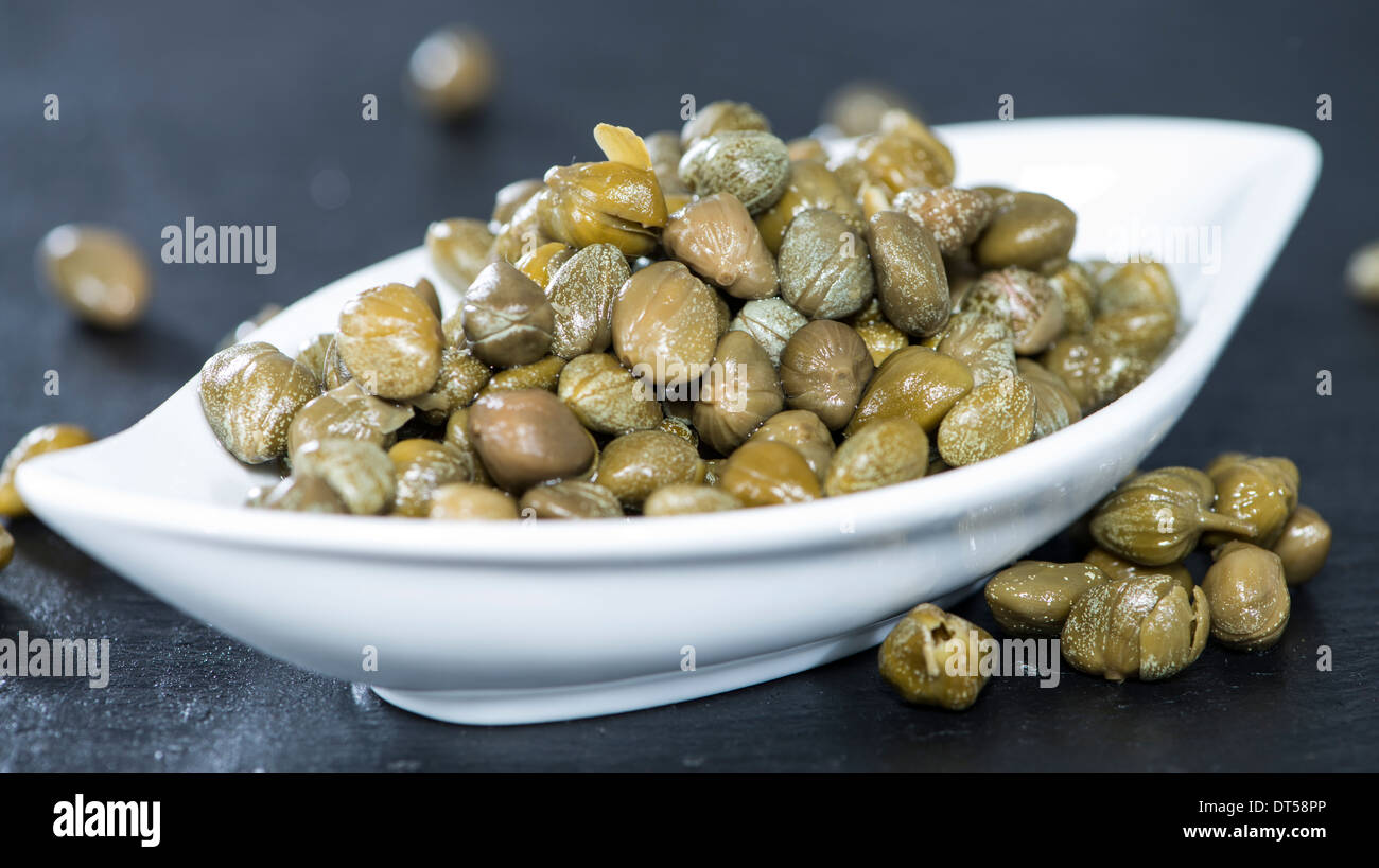 Heap of preserved Capres on vintage background Stock Photo - Alamy