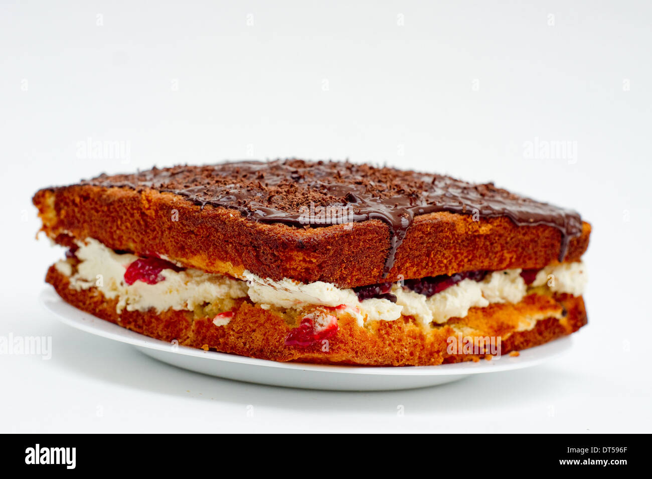 Chocolate topped Sponge with cream and fruit filling Stock Photo - Alamy