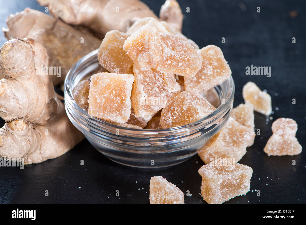 Sweet dried Ginger cubes on dark background Stock Photo - Alamy