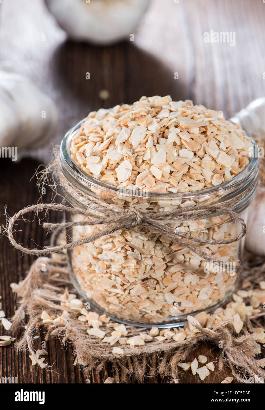 Glass filled with Rubbed Garlic on dark wooden background Stock Photo ...
