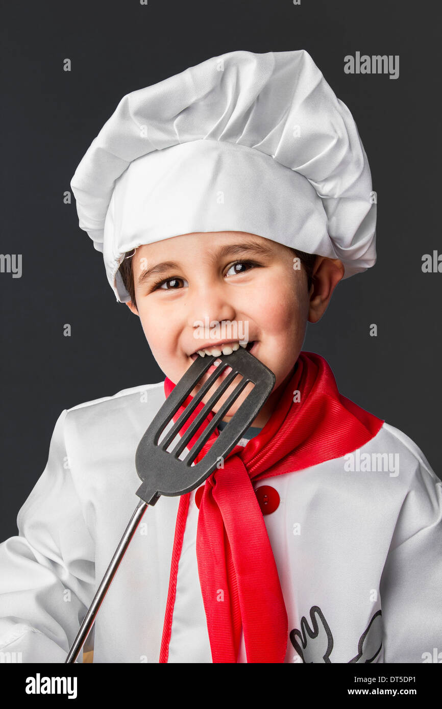 Cooking, Little boy preparing healthy food on kitchen over grey ...