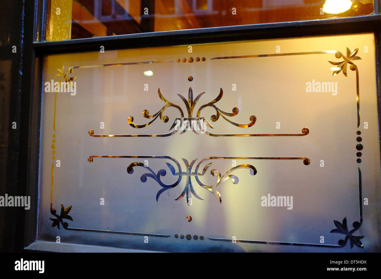 frosted window of a pub with silhouette of drinkers Stock Photo - Alamy