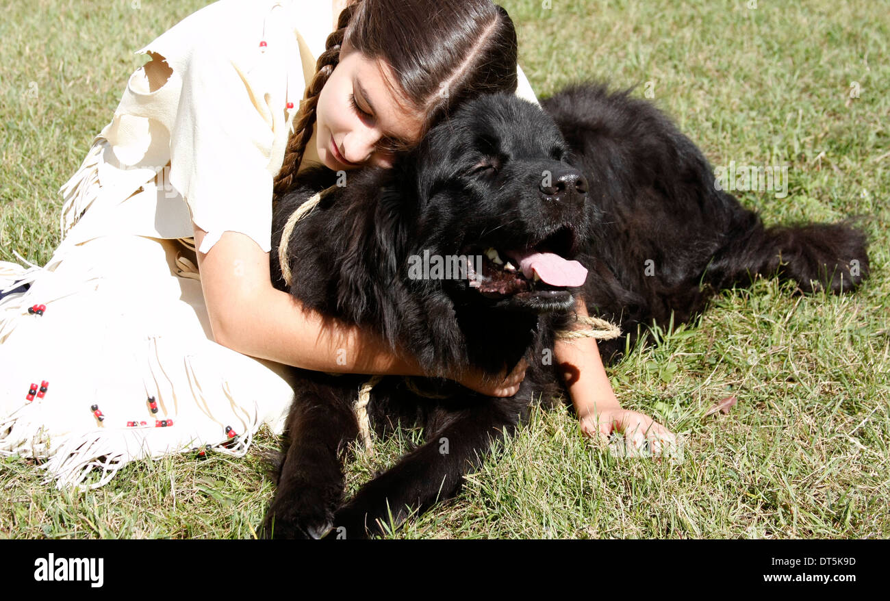 A young Native American Indian girl hugging a black dog Stock Photo - Alamy