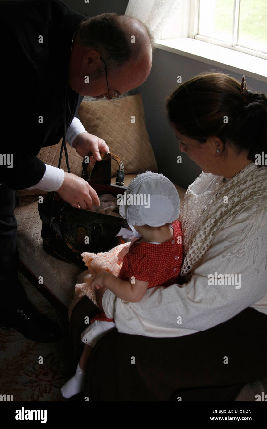 Old fashioned doctor making a house call for a sick baby Stock Photo ...