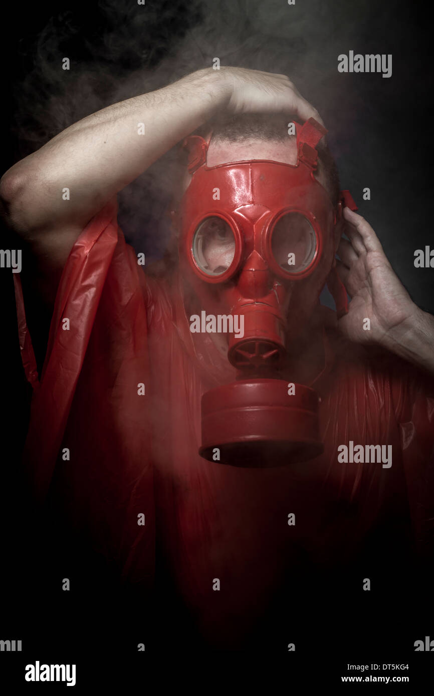 Cloak, A man in a gas mask over the smoke. black background and red ...