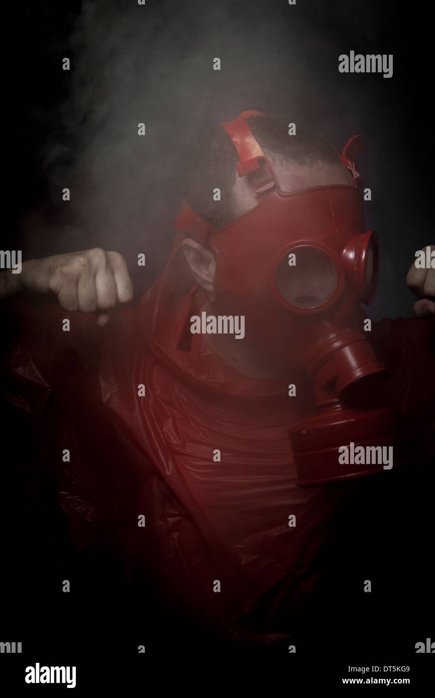 Nuclear, A man in a gas mask over the smoke. black background and red ...