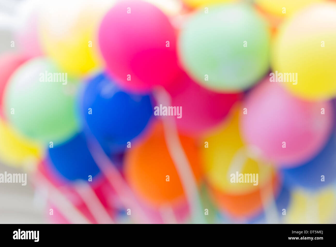 Multi colored toy balloons blurred background Stock Photo - Alamy
