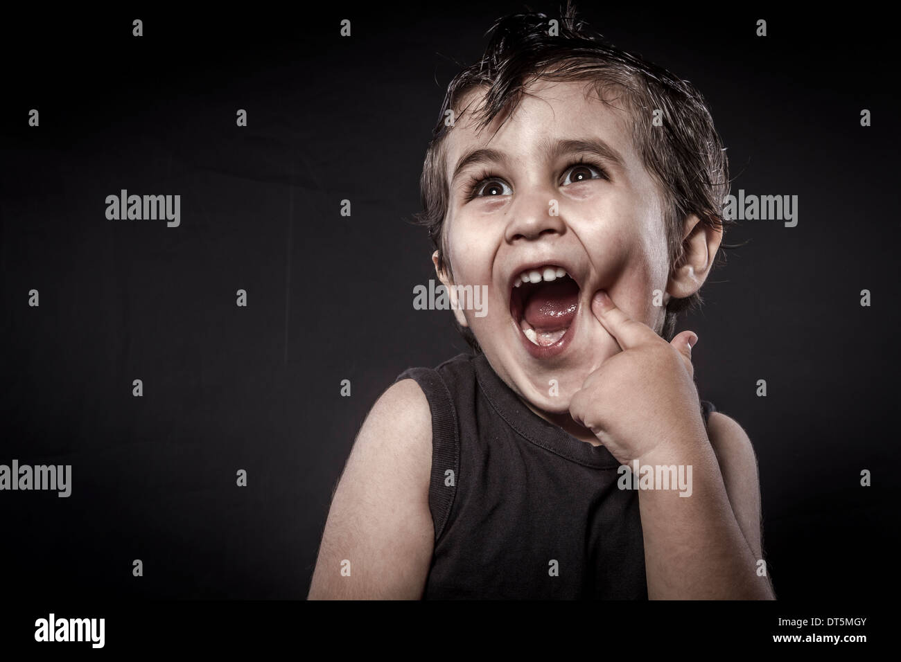 Rock, child rocker dress and funny expressions crested Stock Photo - Alamy