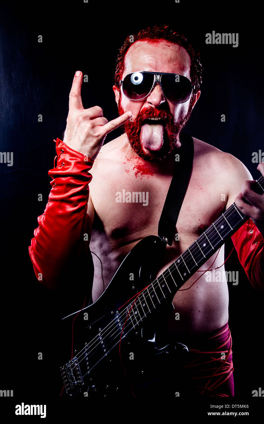 Heavy, guitarist with electric guitar black, wearing face paint and red ...